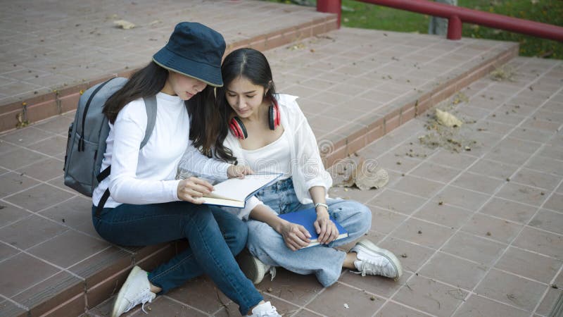 Two Students Sharing Notes while Sitting on Staircase in the University ...