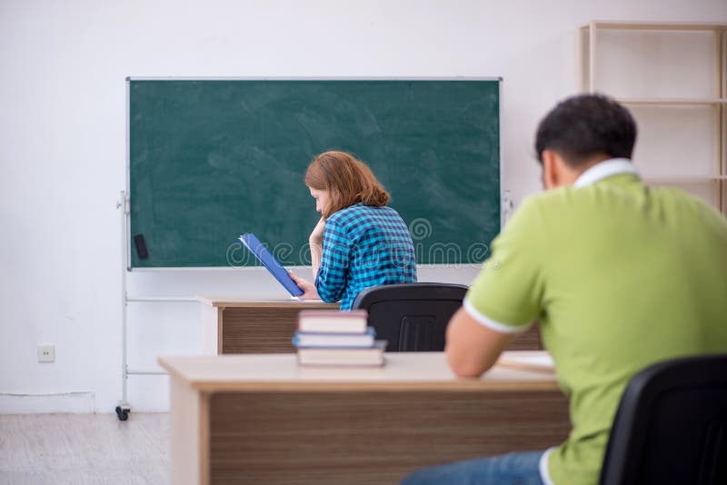 Two Students Sitting in the Classroom Stock Photo - Image of graduation ...
