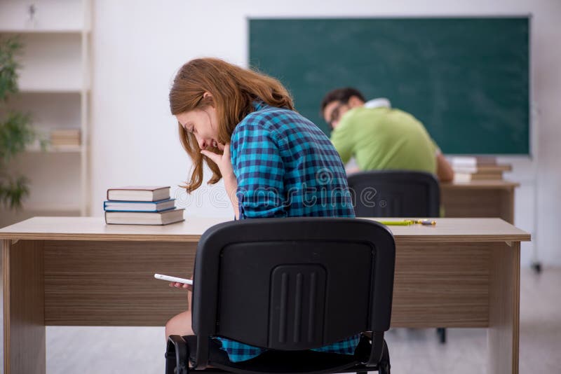 Two Students Sitting in the Classroom Stock Image - Image of games ...