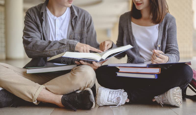 Two Students are Sitting on the Floor Reading Books To Education. Study ...