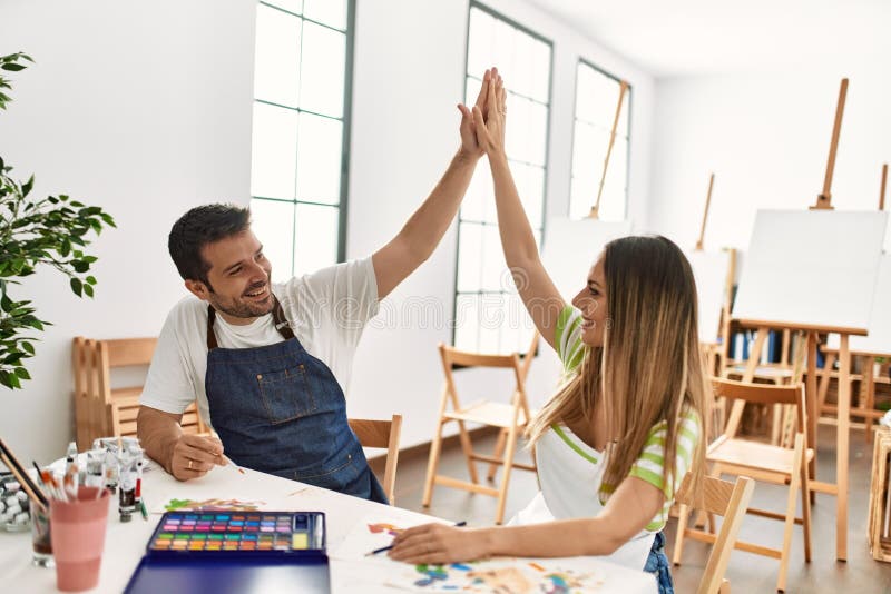Two Students Smiling Happy High Five Sitting on the Table at Art School ...