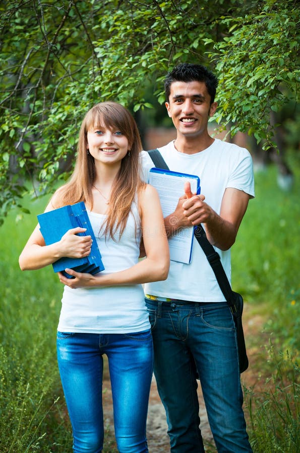 Two Students Studying in Park on Grass with Book Outdoors Stock Image ...