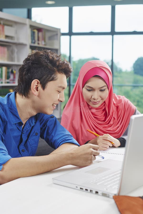 Two Students Studying Together in Library. Conceptual Image Stock Photo ...