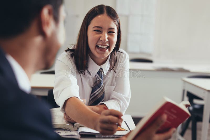 Two Students Talking and Smiling in Classroom Stock Image - Image of ...