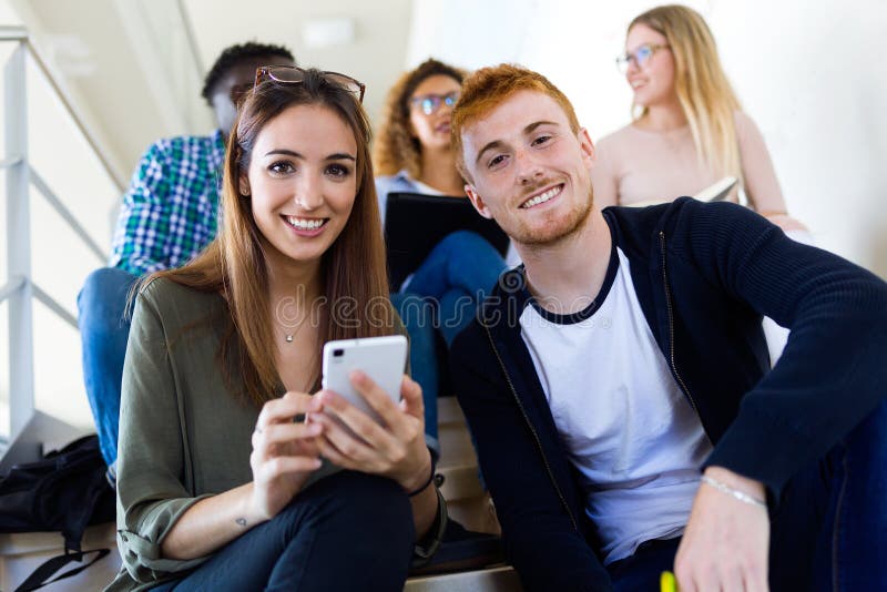 Two Students Using they Mobile Phone in a University. Stock Photo ...