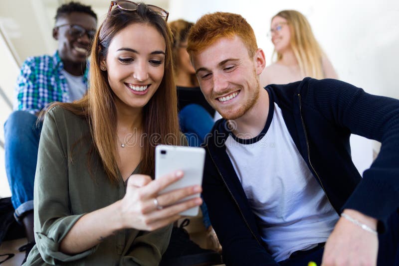 Two Students Using They Mobile Phone In A University. Stock Photo ...