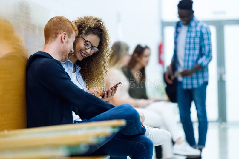 Two Students Using They Mobile Phone In A University. Stock Photo ...
