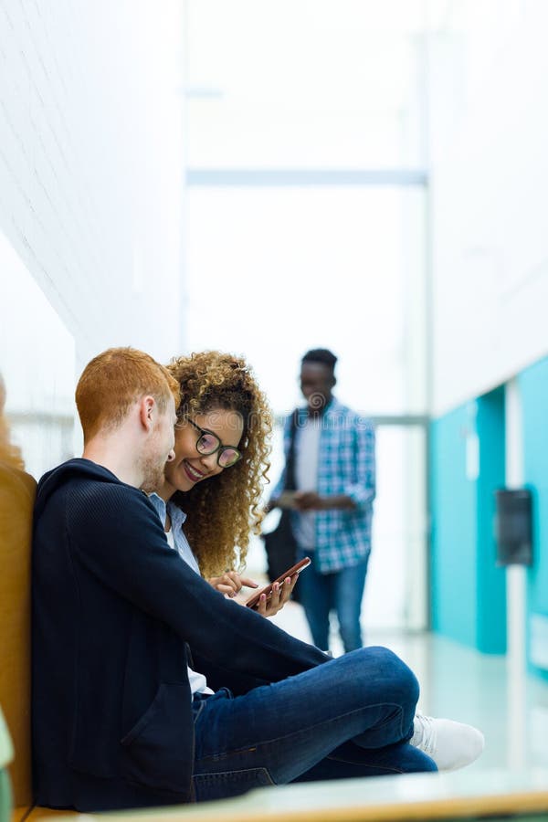 Two Students Using They Mobile Phone In A University. Stock Photo ...
