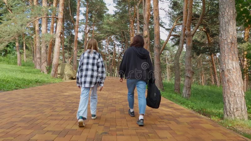 Two Students Walking Away on a Path in a Park Stock Footage - Video of ...