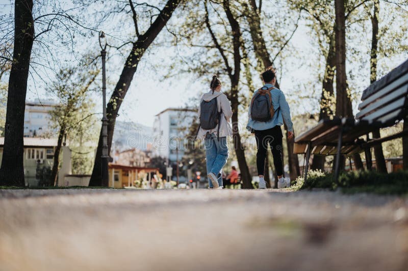 Two Students Walking Together on a Sunny Campus Pathway Stock Photo ...