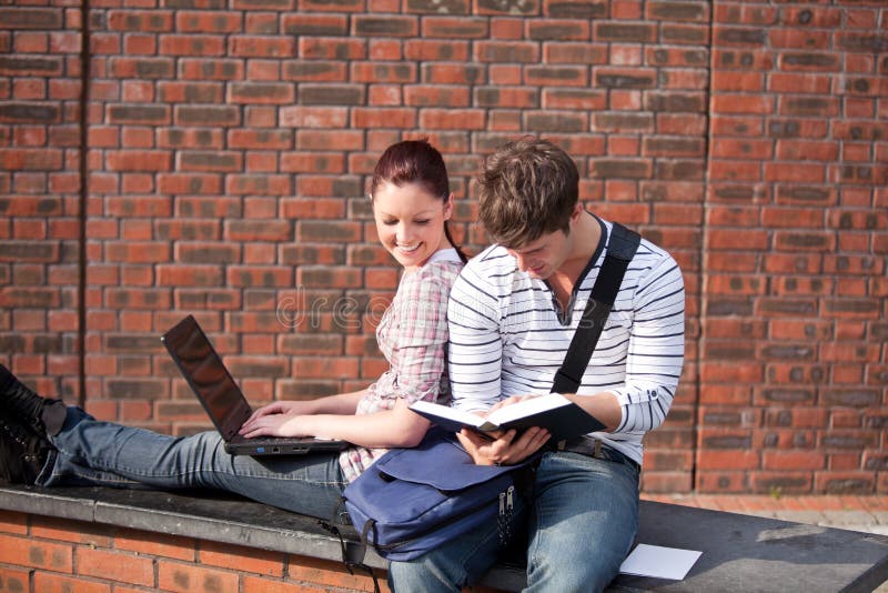 Two Students Working Together with Book and Laptop Stock Image - Image ...