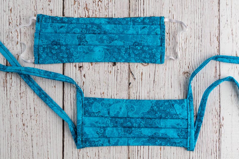Two Styles of Handmade Blue Fabric Protective Face Masks on a Rustic ...