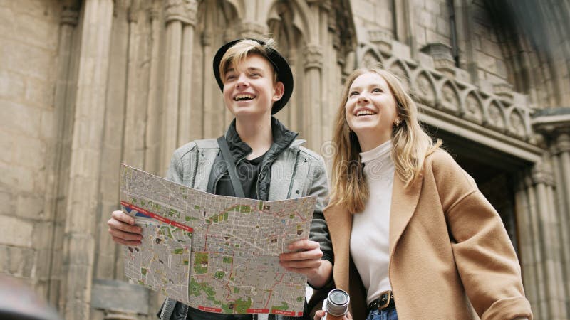 Two Stylish Friend Standing at the Street and Look for Something Using ...