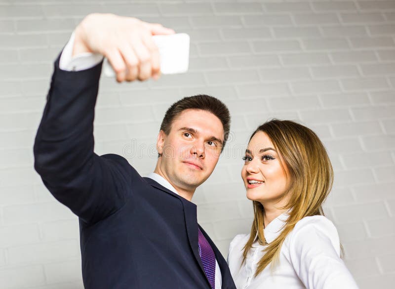 Two Successful Business People Taking A Happy Selfie In The Office