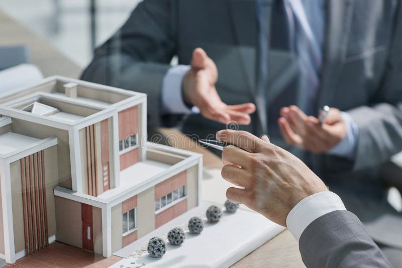 Two Successful People are Discussing a House Construction Project ...