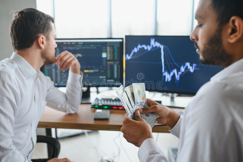 Two Successful Trader Sitting in Office and Looking at Screen, Checking ...