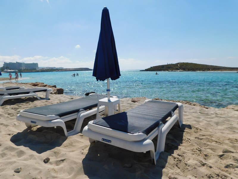 Two Sun Beds and an Umbrella on the Fig Tree Beach. Protaras Stock ...