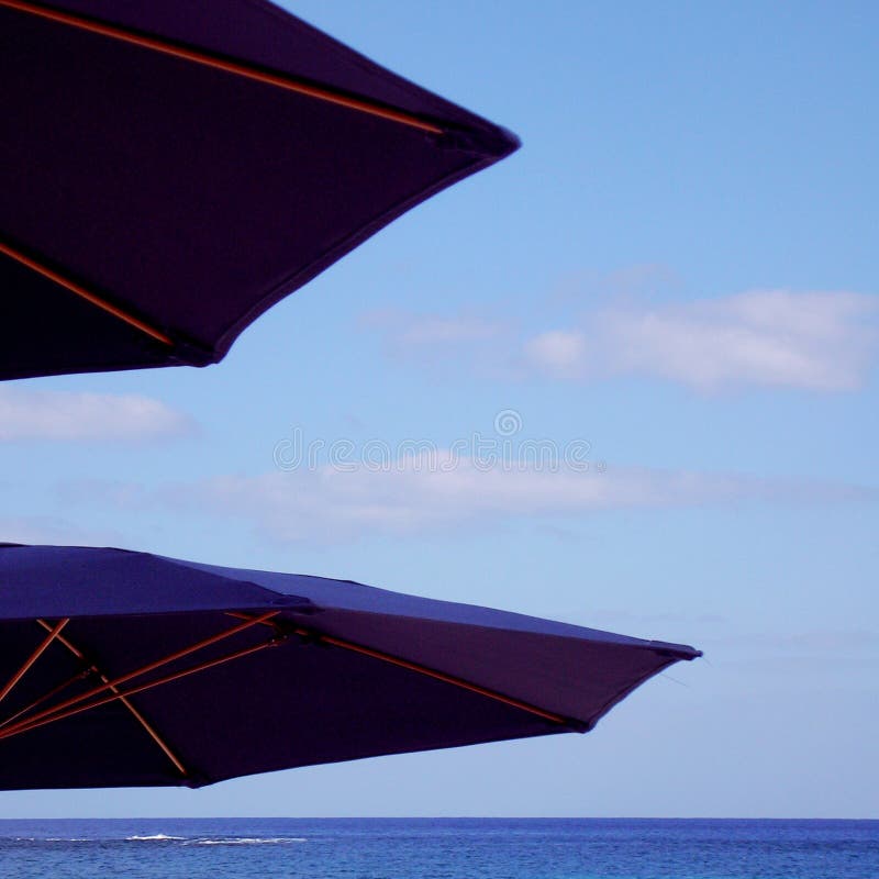 Two sun umbrellas stock image. Image of dark, clouds, beach - 4403383