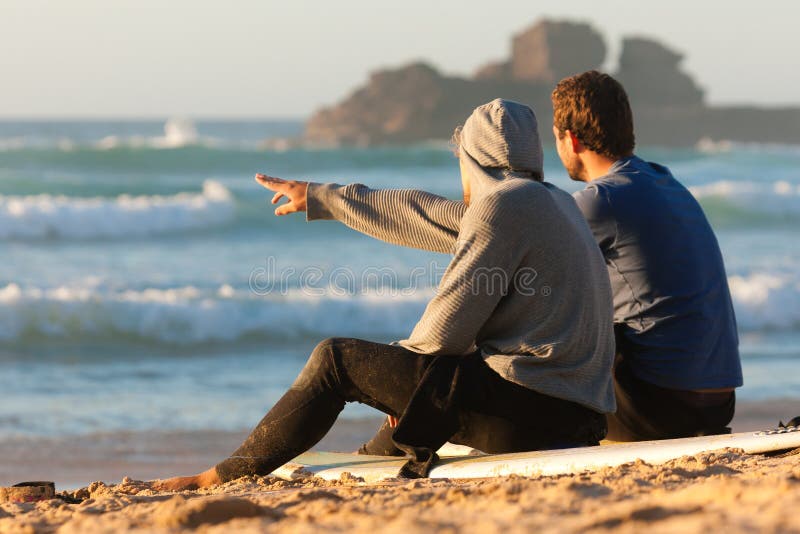 Two Surfers Talking on the Beach Stock Photo - Image of sport, chatting ...
