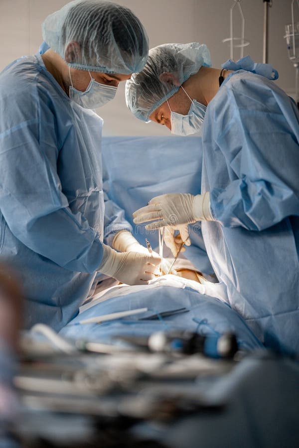 Two Surgeons Operates Abdominal Area of a Patient Stock Image - Image ...
