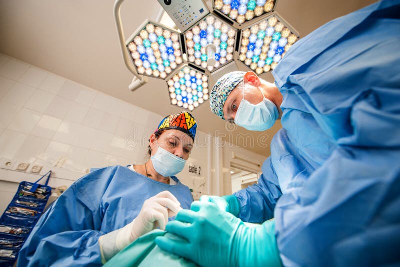 Two Surgeons in Operating Room Making Face Plastic Surgery. Editorial ...