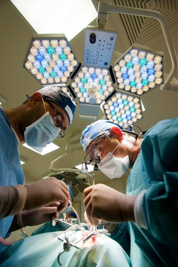 Two Surgeons in Operating Room Making Plastic Surgery. Editorial Image ...