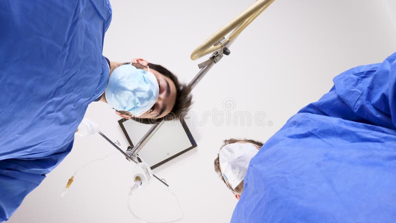 Two Surgeons after a Successful Operation are Talking Over the Patient ...