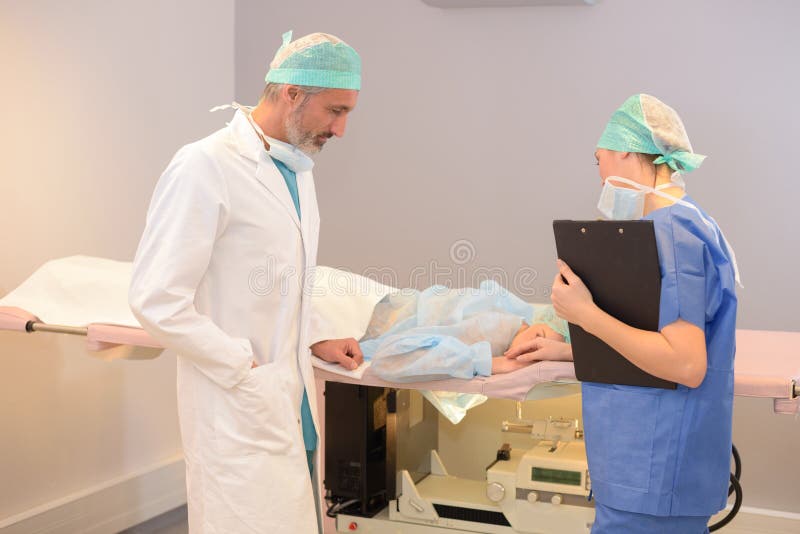 Two Surgeons Talking in Operating Room Stock Photo - Image of hospital ...