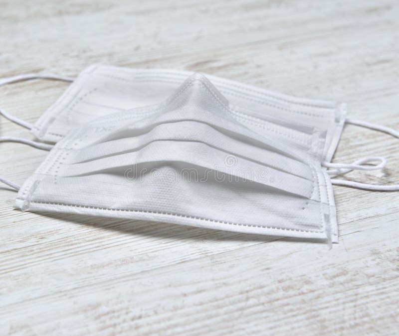 Two Surgical White Mask on a White Wooden Background Stock Image ...