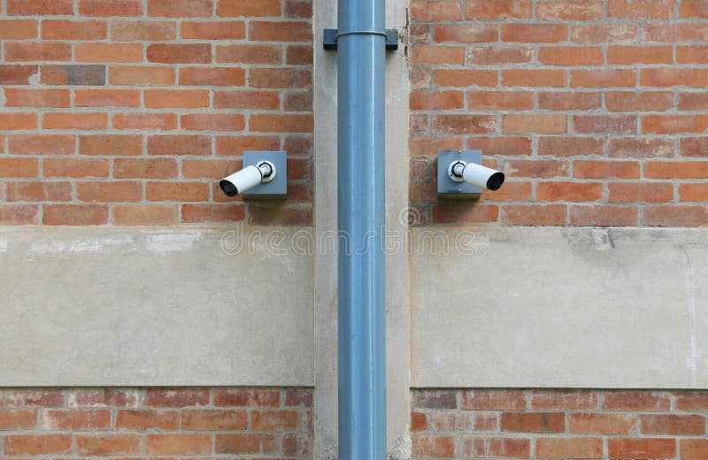Two Surveillance Cameras on Red Brick Wall Stock Photo - Image of ...