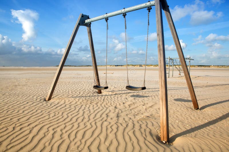 Two Swings in the Sand by the Beach Stock Photo - Image of water ...