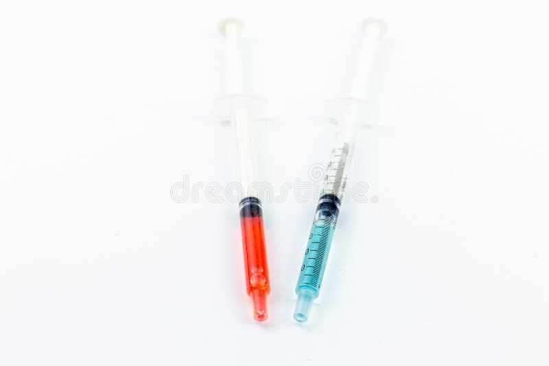 Two Syringes with Red and Blue Liquid Isolated on White Background ...