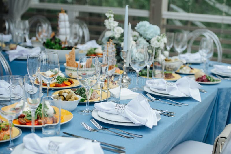 Two Tables Setting for an Event on a Terrace. Empty Plates with Napkins ...