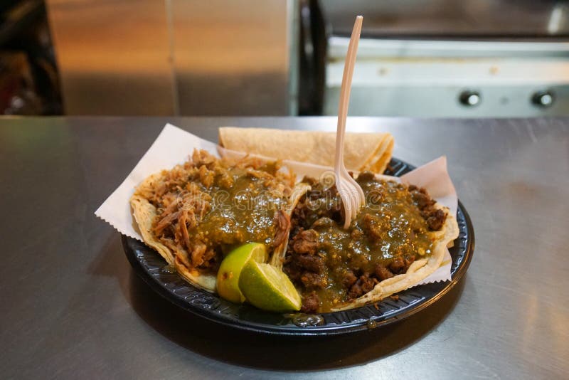 Two tacos on a black plate stock image. Image of beef - 169809301