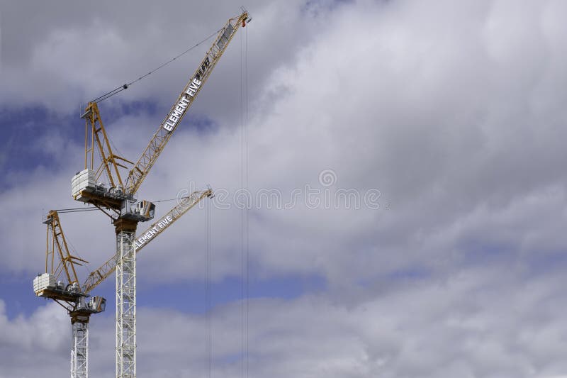 Two Tall Cranes with Cabin Against a Cloudy Blue Sky Editorial Stock ...