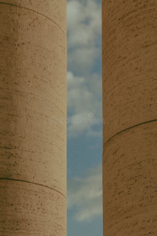 Two Tall Pillars Standing Side by Side in Front of a Blue Sky with ...