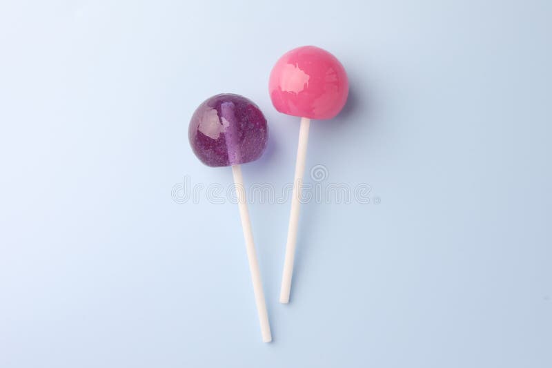 Two Tasty Lollipops on Light Blue Background, Flat Lay Stock Image ...