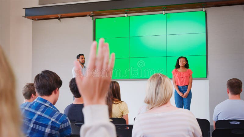 Two Teachers Giving Presentation To High School or University Class in ...