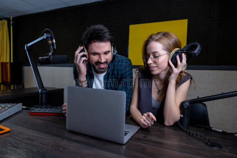 Two Team Members Having a Sound Check and Looking Involved Stock Photo ...