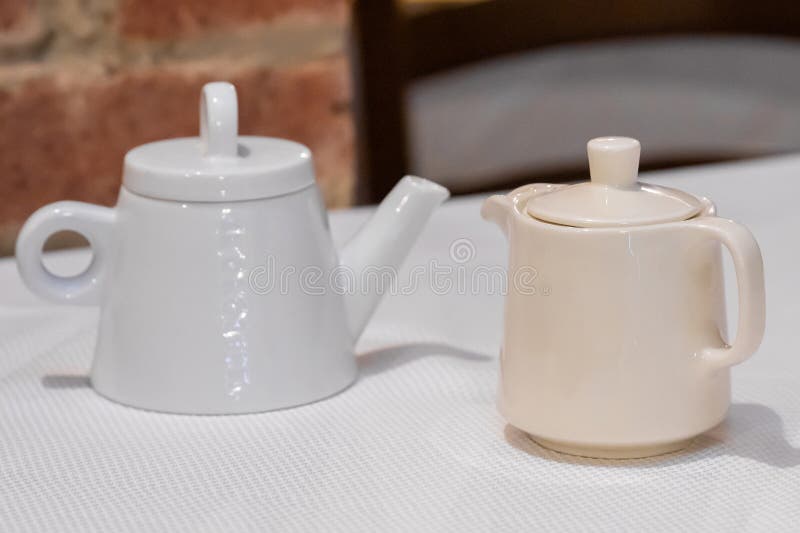 Two Teapots on Table with Brick Wall Background Stock Photo - Image of ...