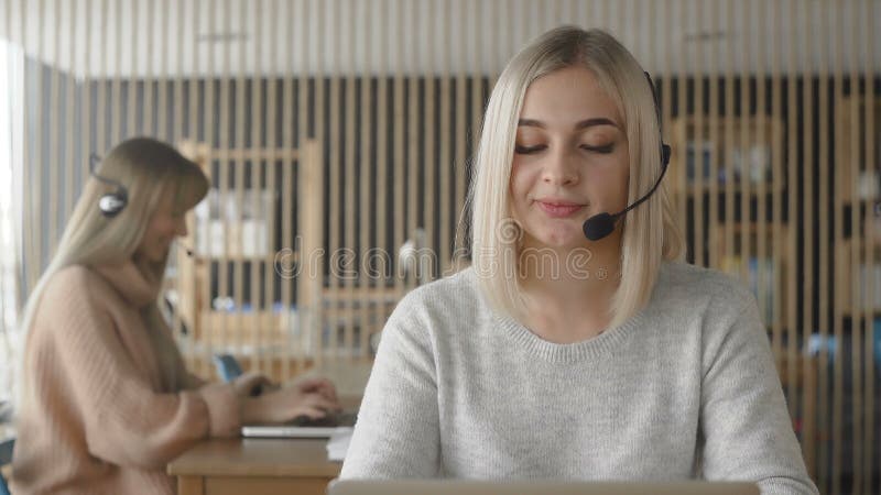 Two Technical Support Specialist Talking with Customers by Headsets ...