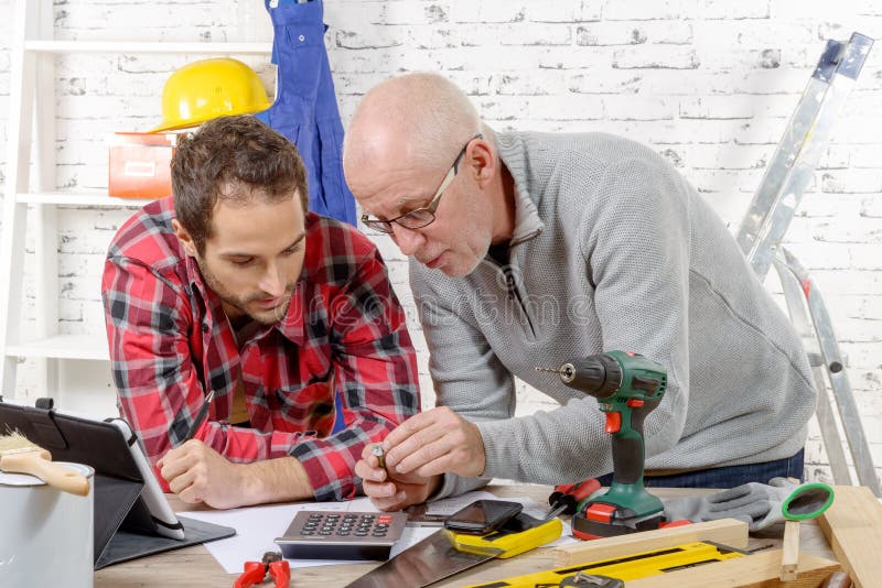 Two Technician Examining Mechanical Part in the Workshop Stock Image ...