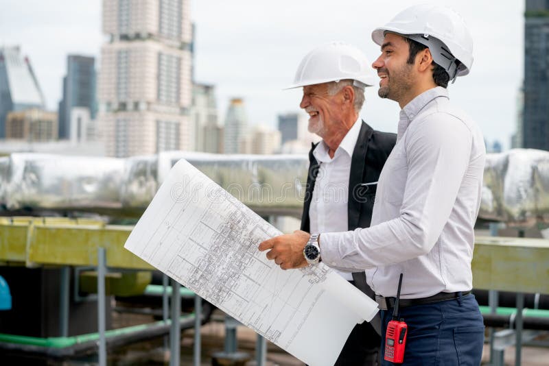 Two Technician or Professional Engineers Express Happiness during Work Together on Rooftop of ...