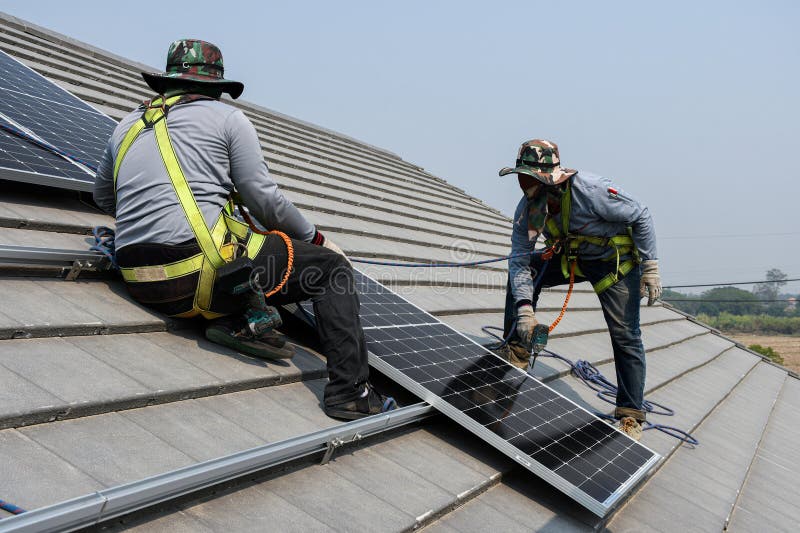 Two Technicians are Installing Solar Panels on the Roof To Use Solar ...