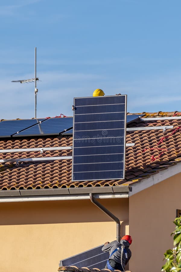Two Technicians, Specialized in Photovoltaic Systems, Work on a Roof To ...