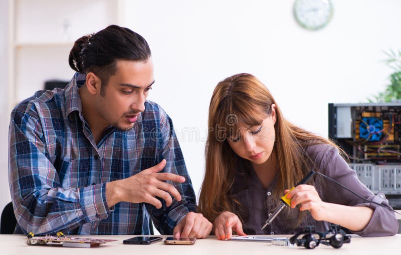 Two Technicians Working at Computer Warranty Center Stock Image - Image ...