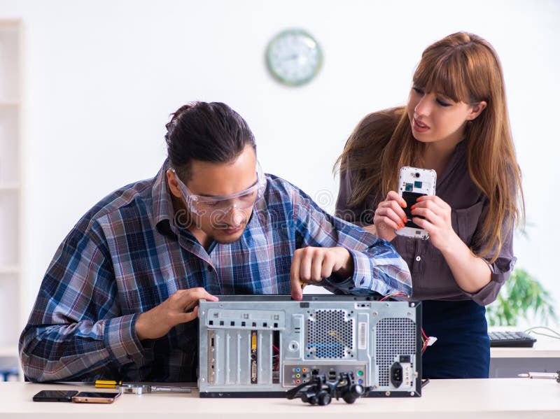 Two Technicians Working at Computer Warranty Center Stock Photo - Image ...