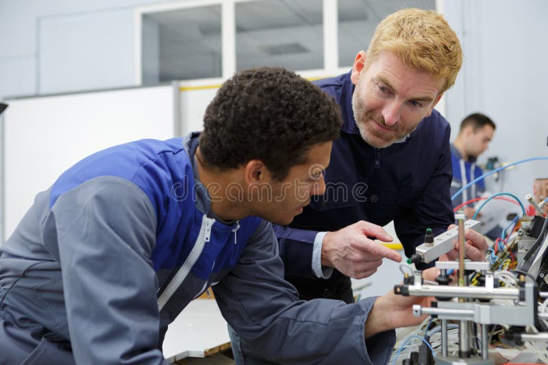 Two Technicians Working on Machine in Factory Stock Photo - Image of ...