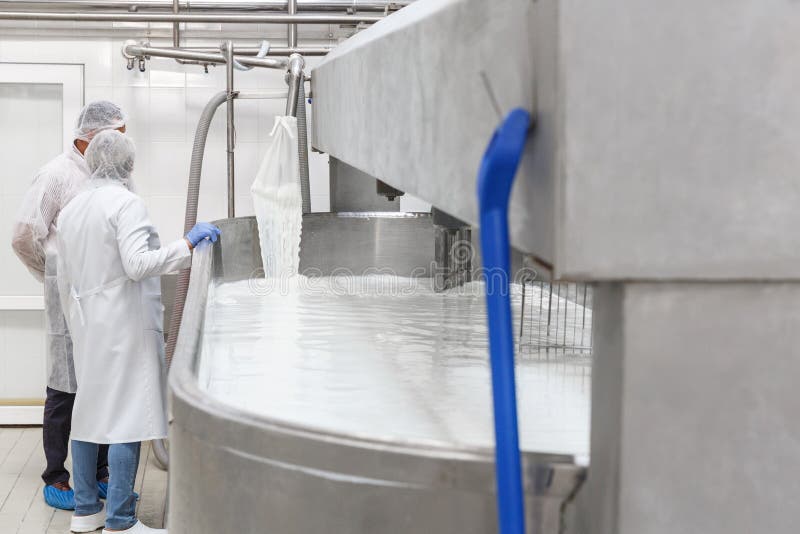 Two Technologists Standing at the Stainless Mixing Tank with Milk ...