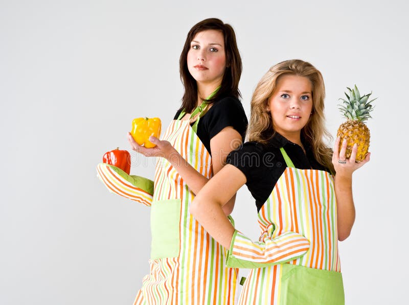 Two teenage cooks stock photo. Image of female, aprons - 4931224